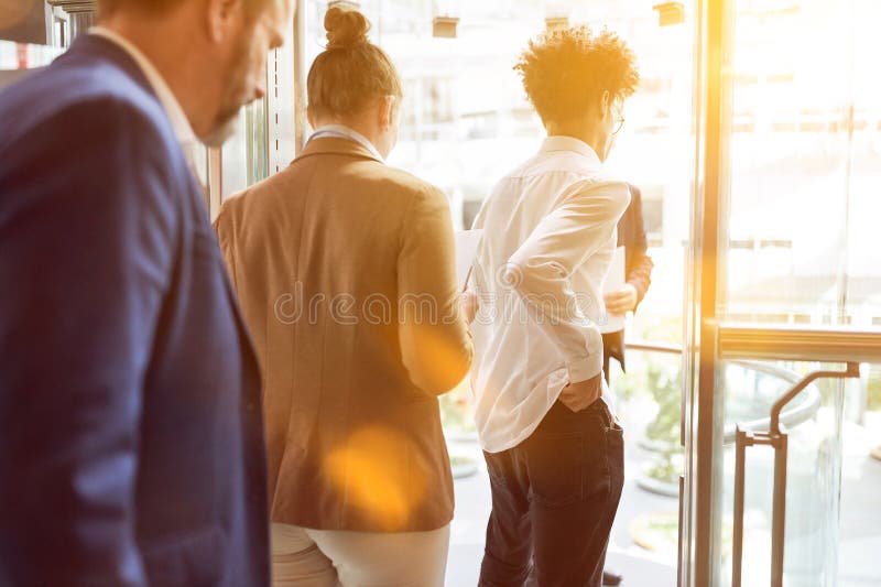 Group of Business People from Behind Goes through a Door Stock Photo ...
