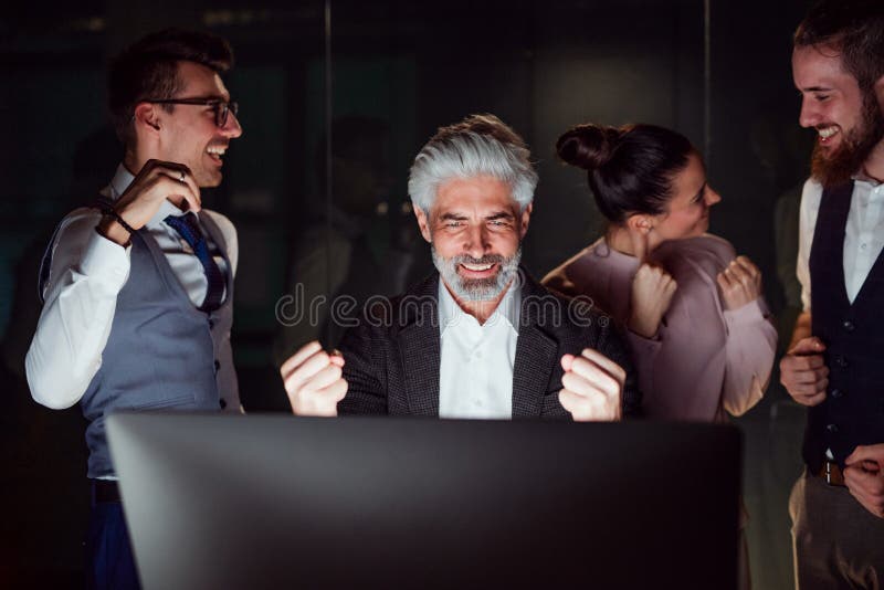 A Group of Business People with Computer in an Office, Expressing ...