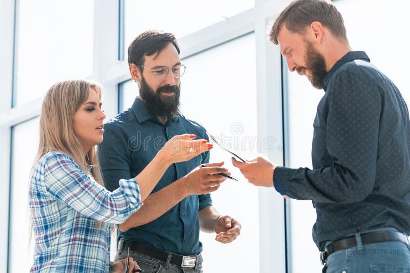 Group of Business People Discussing Documents Standing in the Office ...