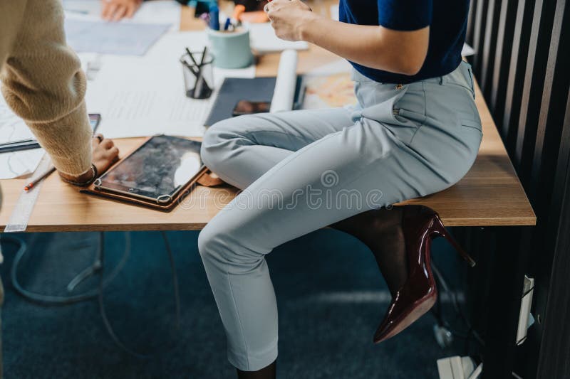 Group of Business People Gathered Around a Desk, Actively Brainstorming ...