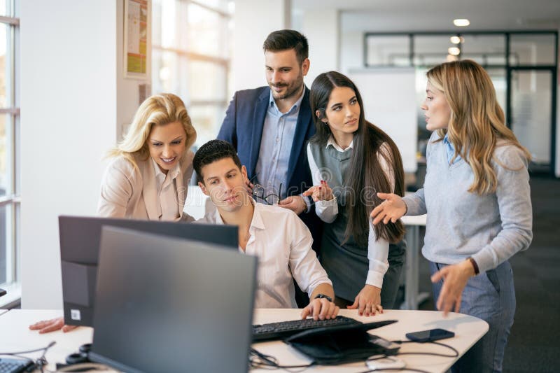 Group of Business People Gathered Together at a Table Working on ...