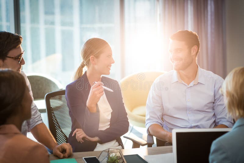Group of Business People Interacting at Desk Stock Image - Image of ...