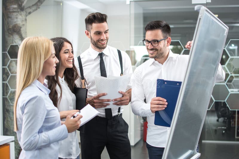 Group of Business People Looking at the Graph on Flipchart. Stock Photo ...