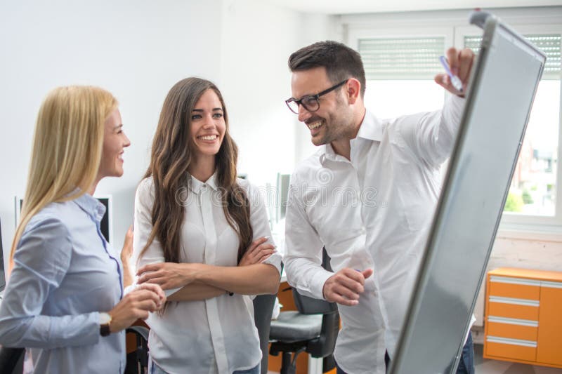 Group of Business People Looking at the Graph on Flipchart at Office ...