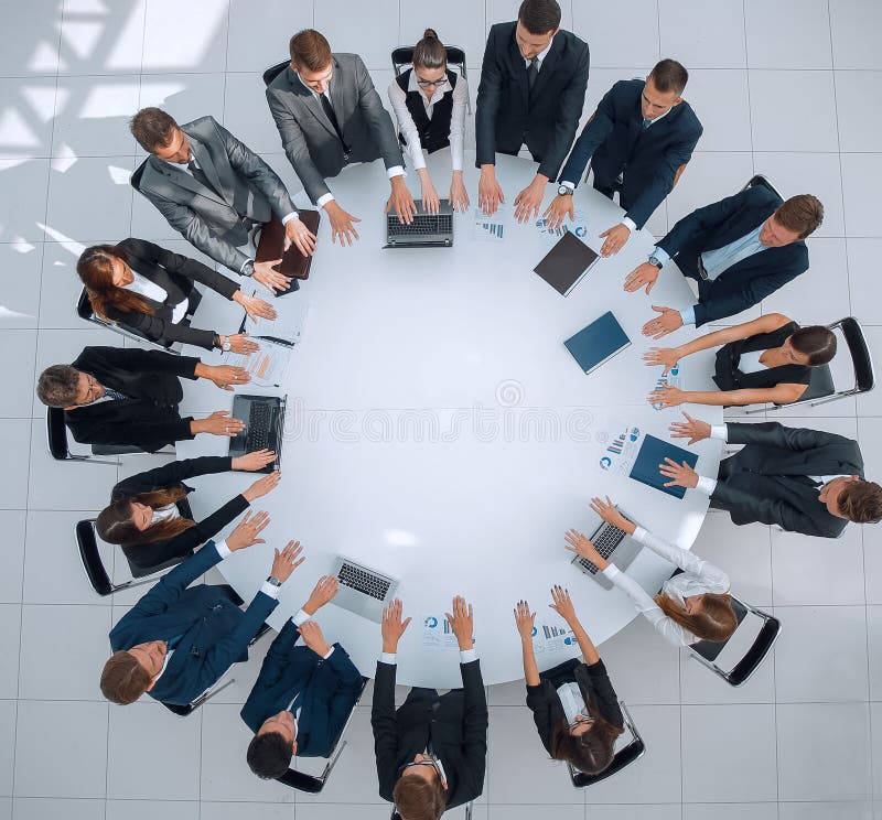 Group of Business People Sitting at the Round Table, and Putting His ...