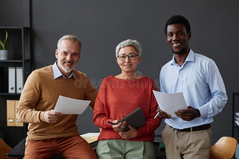 Group of Business People with Smiling Senior Workers Stock Photo ...