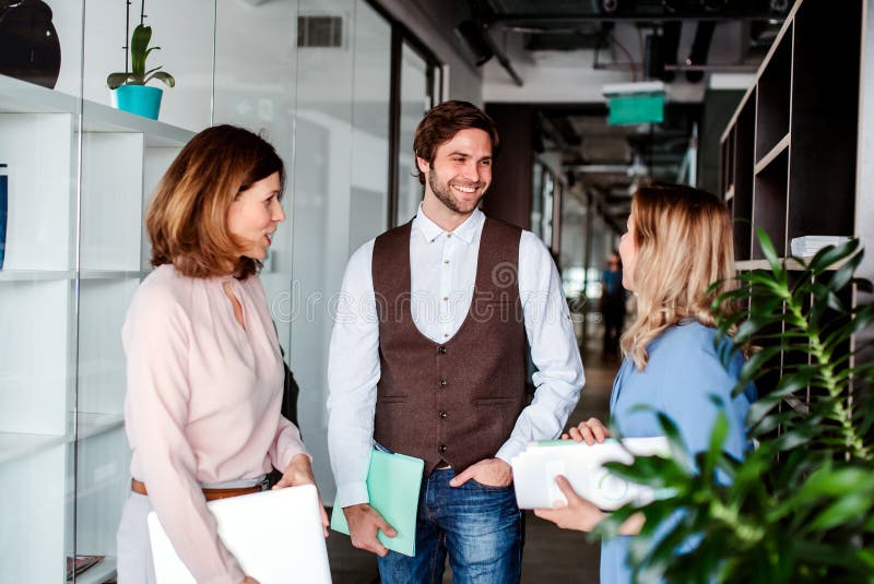 Group of Business People Standing in an Office Building, Talking. Stock ...