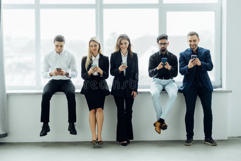 Group of Business People Using Mobile Phones and Sitting on Couch ...