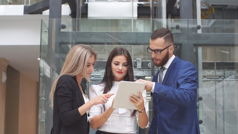Group of Business People Using Tablet Computer during a Meeting. Stock ...