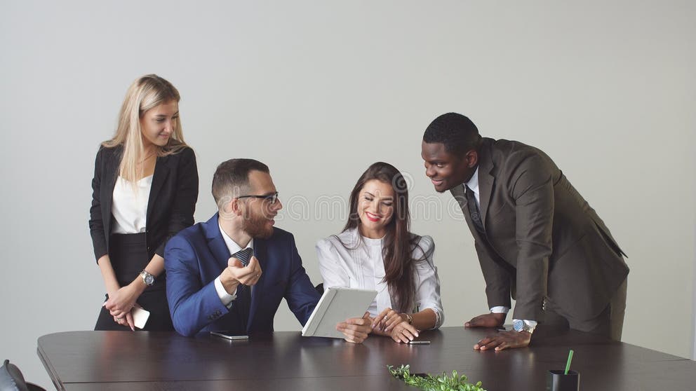 Group of Business People Using Tablet Computer during a Meeting. Stock ...