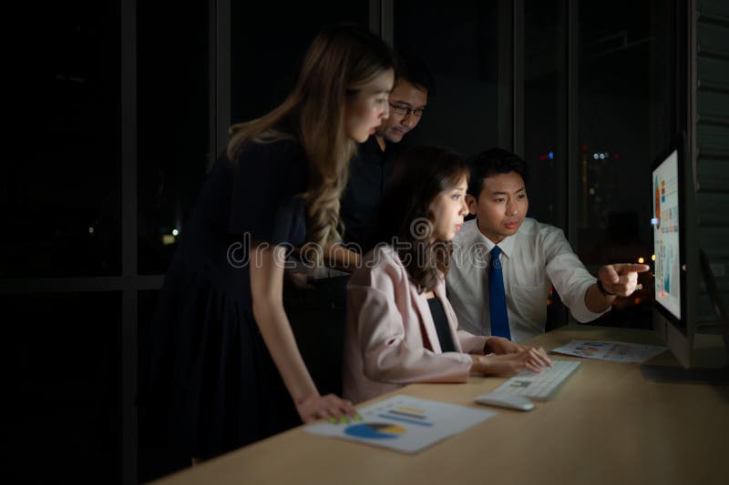 Group of Business People Working in Office at Night. Stock Photo ...