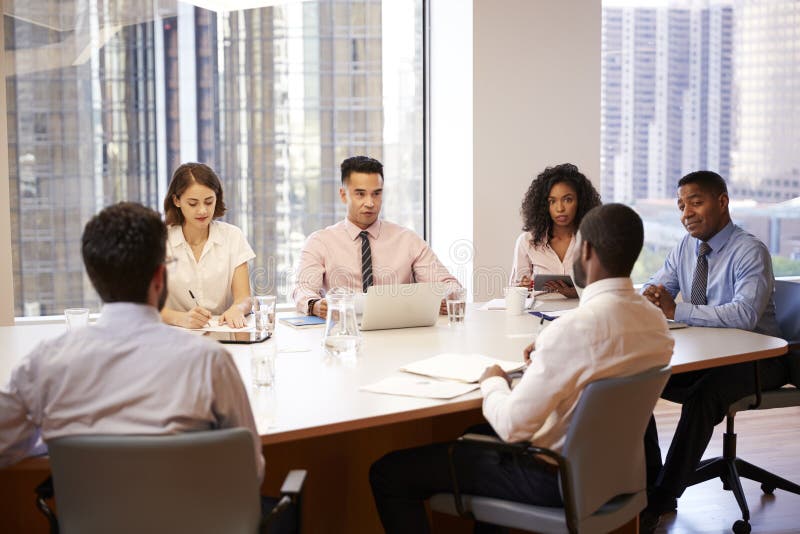 Group of Business Professionals Meeting Around Table in Modern Office ...