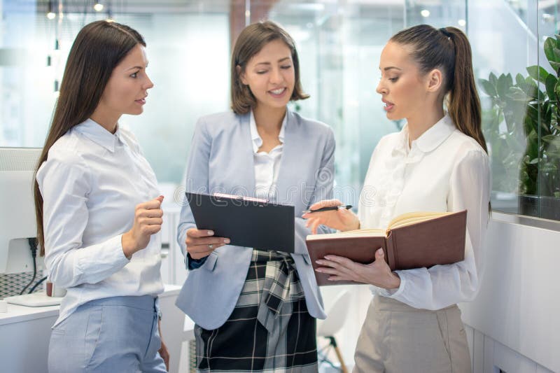 Group of Business Women Working Together on Contract Documents in ...