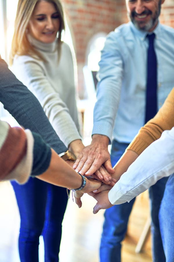 Group of Business Workers Standing with Hands Together at the Office ...
