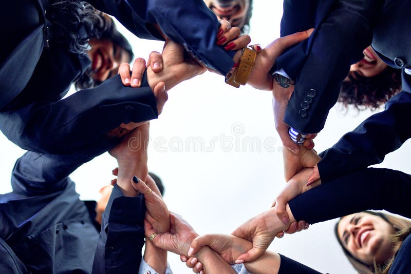 Group of Business Workers Standing with Hands Together at the Office ...