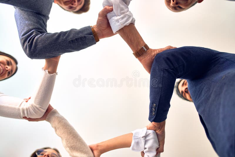 Group of Business Workers Standing with Hands Together at the Office ...