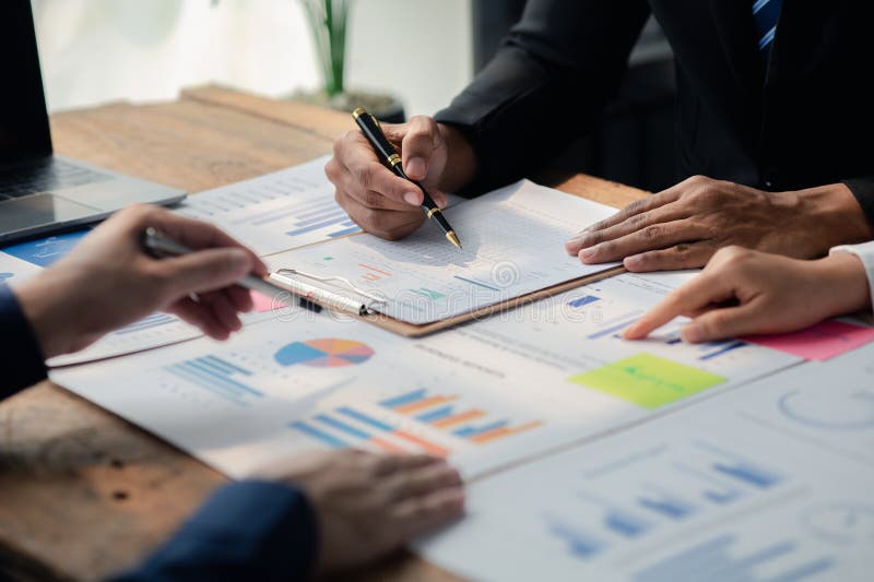 Group Businessmen Point To the Material for the Meeting, Working ...