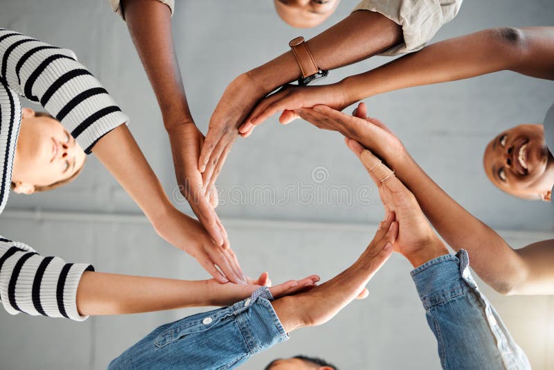 Group of Businesspeople Forming a Circle with Their Hands in an Office ...