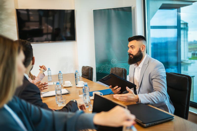 Group of Businesspeople Having a Briefing in a Boardroom Stock Photo ... Group of Businesspeople Having a Briefing in a Boardroom Stock Photo ...