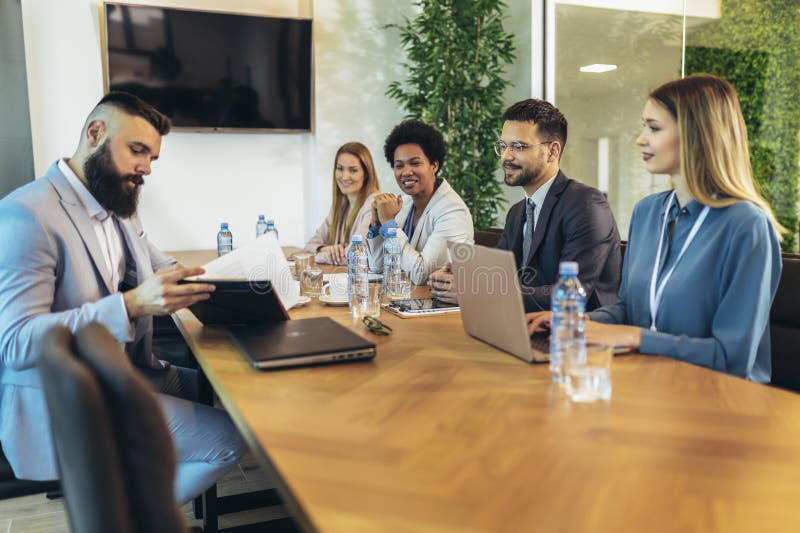 Group of Businesspeople Having a Briefing in a Boardroom Stock Photo ...