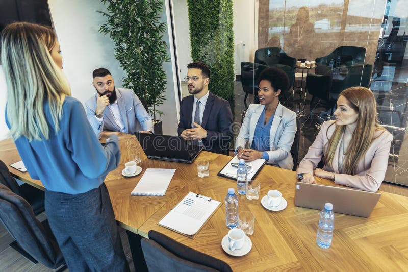 Businesspeople Having a Briefing in a Boardroom. Businesspeople Working ...