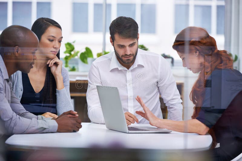 Lets Fix this As a Team. a Group of Businesspeople Having a Meeting in ...