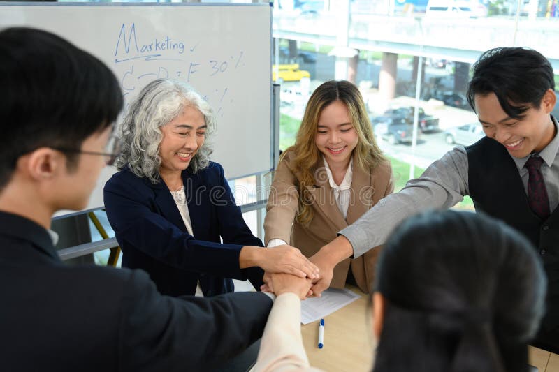 Group of Businesspeople Joining Hands Together To Celebrating ...