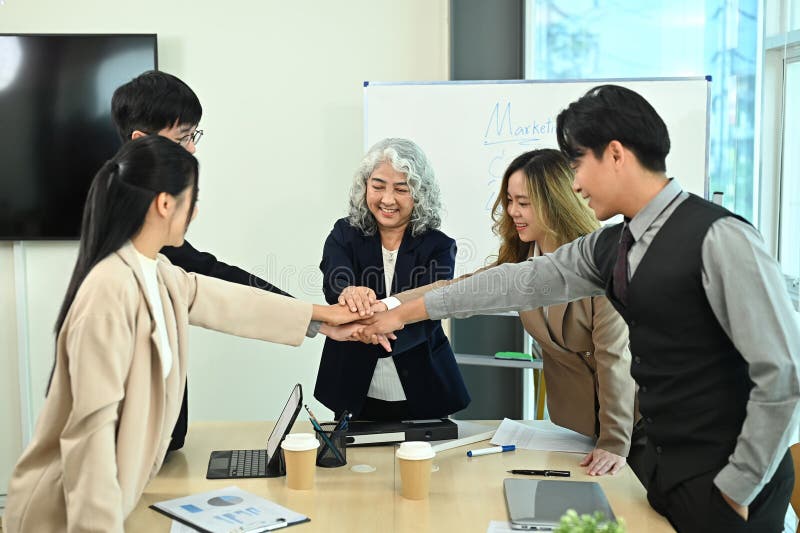 Group of Businesspeople Joining Hands Together To Celebrating ...