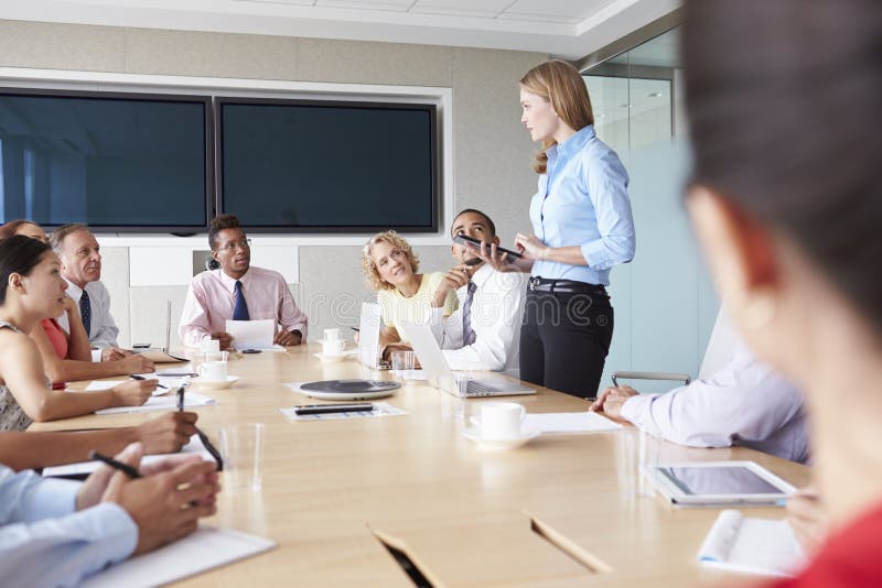 Group of Businesspeople Meeting Around Boardroom Table Stock Photo ...