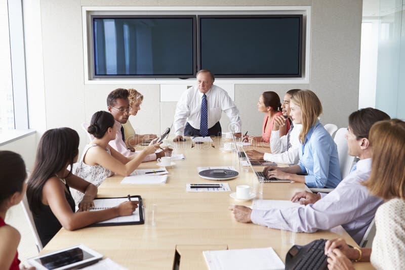 Group of Businesspeople Meeting Around Boardroom Table Stock Photo ...