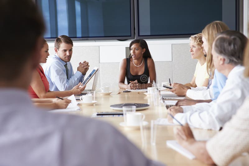Group of Businesspeople Meeting Around Boardroom Table Stock Photo ...