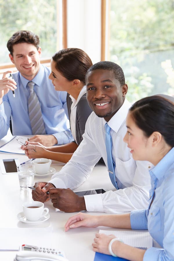 Group of Businesspeople Meeting Around Boardroom Table Stock Photo ...