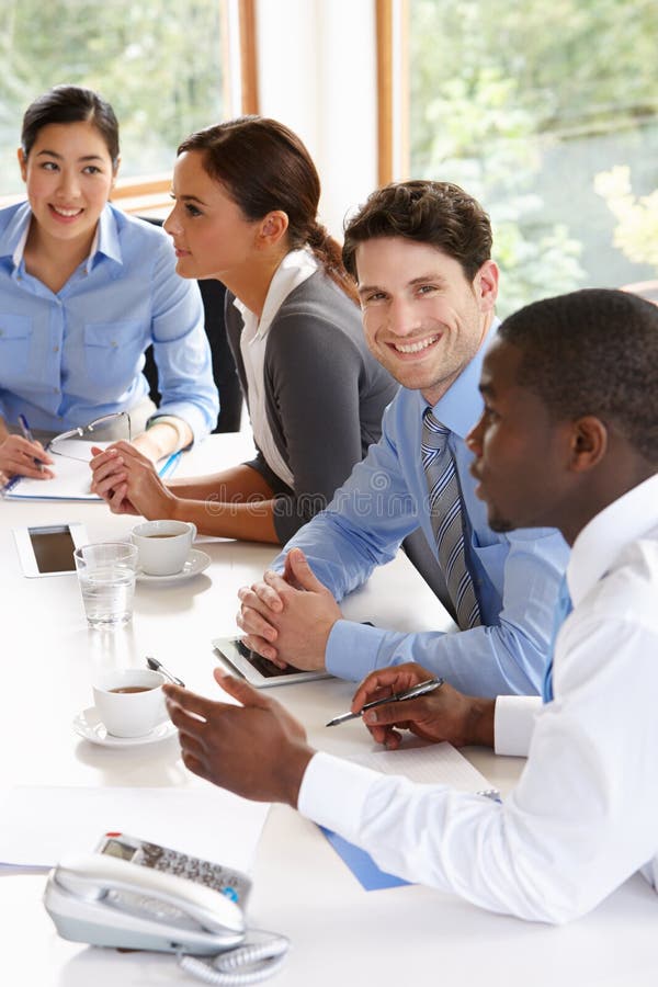 Group of Businesspeople Meeting Around Boardroom Table Stock Photo ...