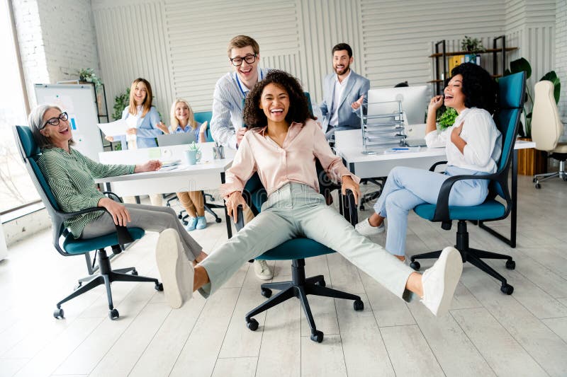 Diverse Office Team Enjoying a Lighthearted Moment Together in an Open ...