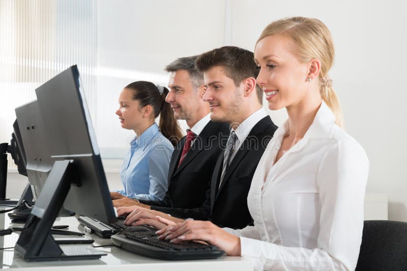 Businesspeople Typing on Desktop Computer Stock Photo - Image of adult ...