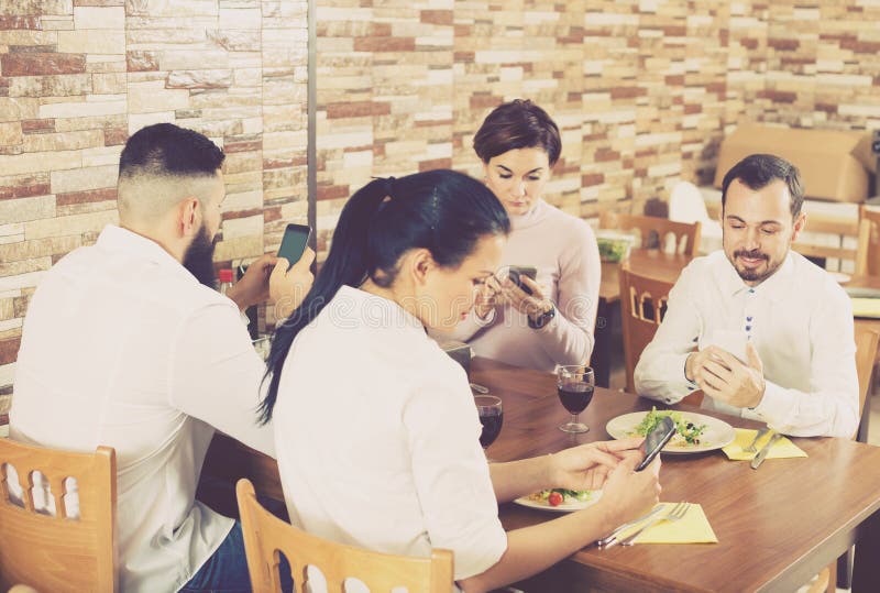 Group of Busy Friends Using Smartphones at Restaurant Stock Image ...