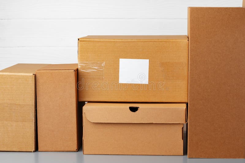 Group of Cardboard Boxes Against White Wooden Wall Stock Photo - Image ...