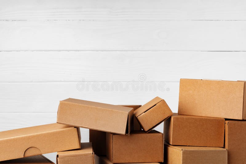Group of Cardboard Boxes Against White Wooden Wall Stock Image - Image ...