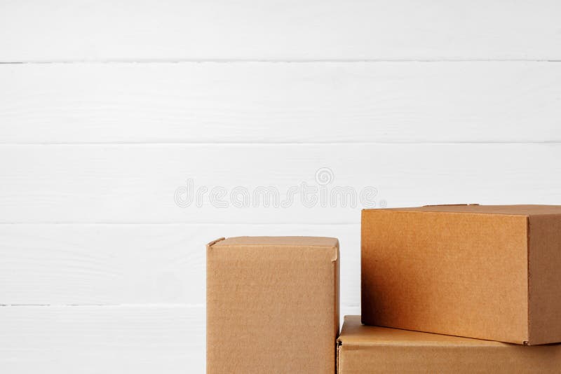 Group of Cardboard Boxes Against White Wooden Wall Stock Image - Image ...