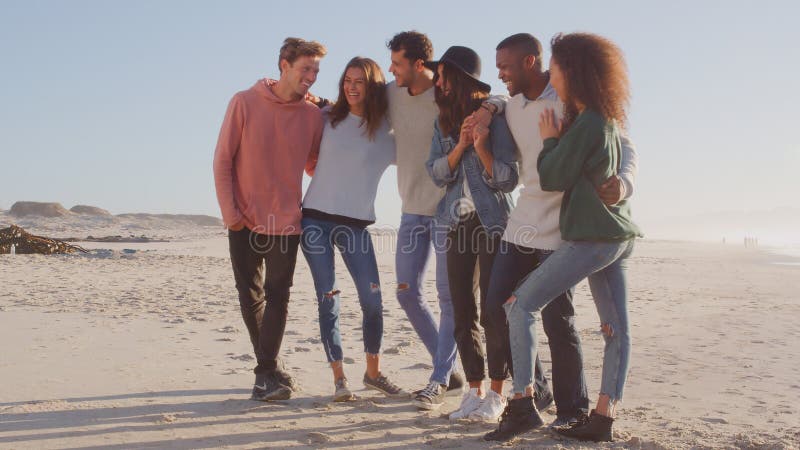 Group of Casually Dressed Friends Having Fun Standing on Winter Beach ...