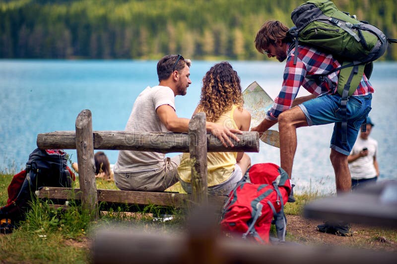 Group of People Taking a Break in Nature, Looking at the Map Stock ...