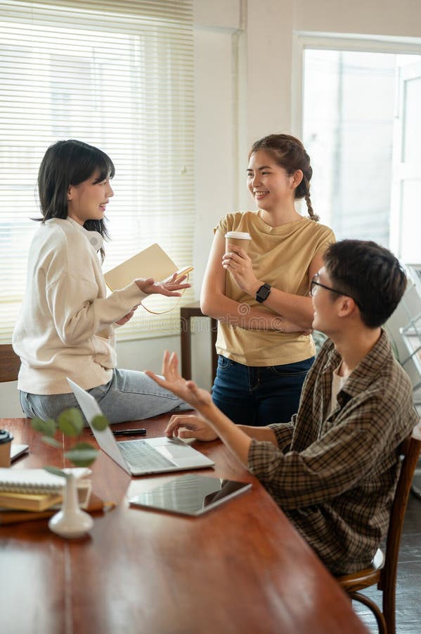 A Group of Cheerful Asian Students are Sharing Their Ideas, and ...