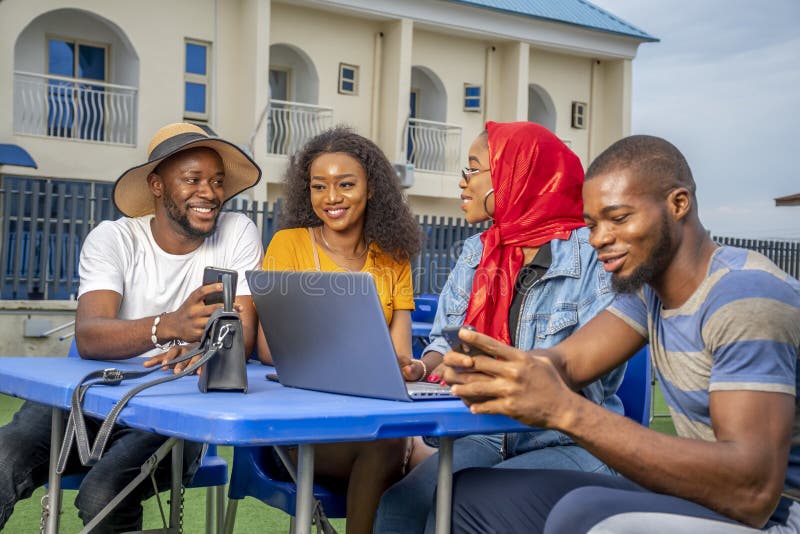 Group of Cheerful Friends Communicating and Using Devices Stock Photo ...