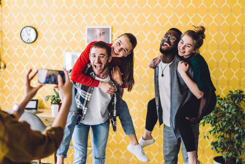 Group of Cheerful Friends Photographing Together at Home Stock Photo ...