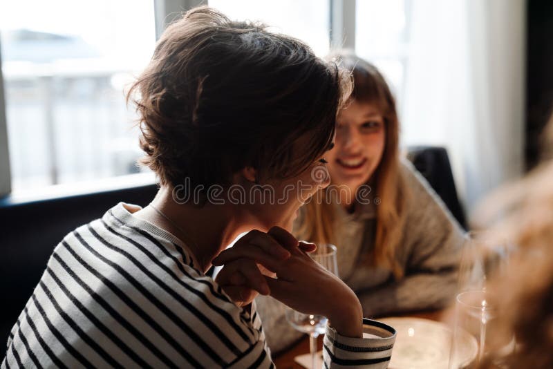 Group of Cheerful Friends Talking while Dining in Restaurant Stock ...
