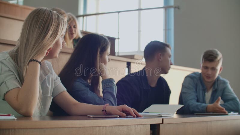 The Group of Cheerful Happy Students Sitting in a Lecture Hall before ...