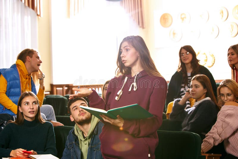 The Group of Cheerful Happy Students Sitting in a Lecture Hall before ...