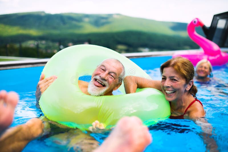 Group of Cheerful Seniors in Swimming Pool Outdoors in Backyard, Having ...
