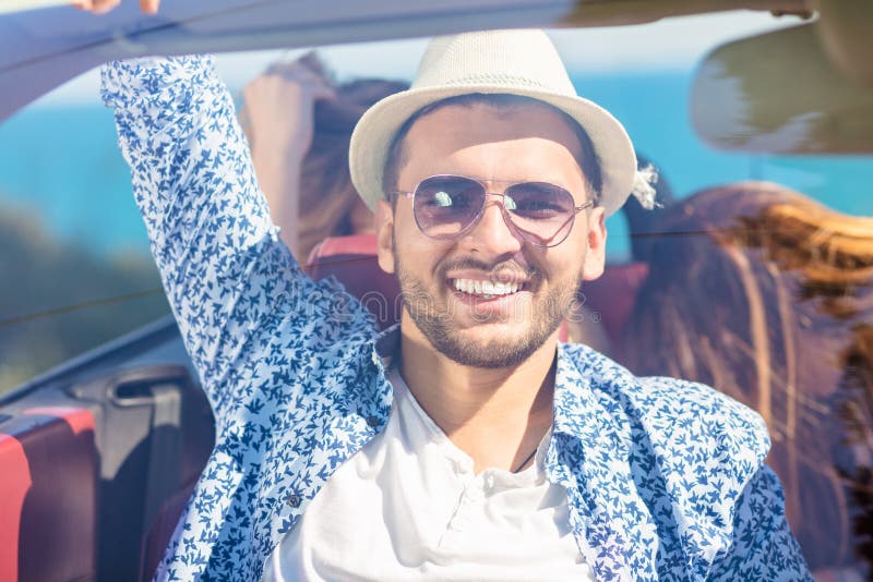 Group of Cheerful Young Friends Driving Car and Smiling in Summer Stock ...
