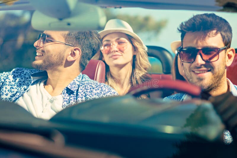Group of Cheerful Young Friends Driving Car and Smiling in Summer Stock ...